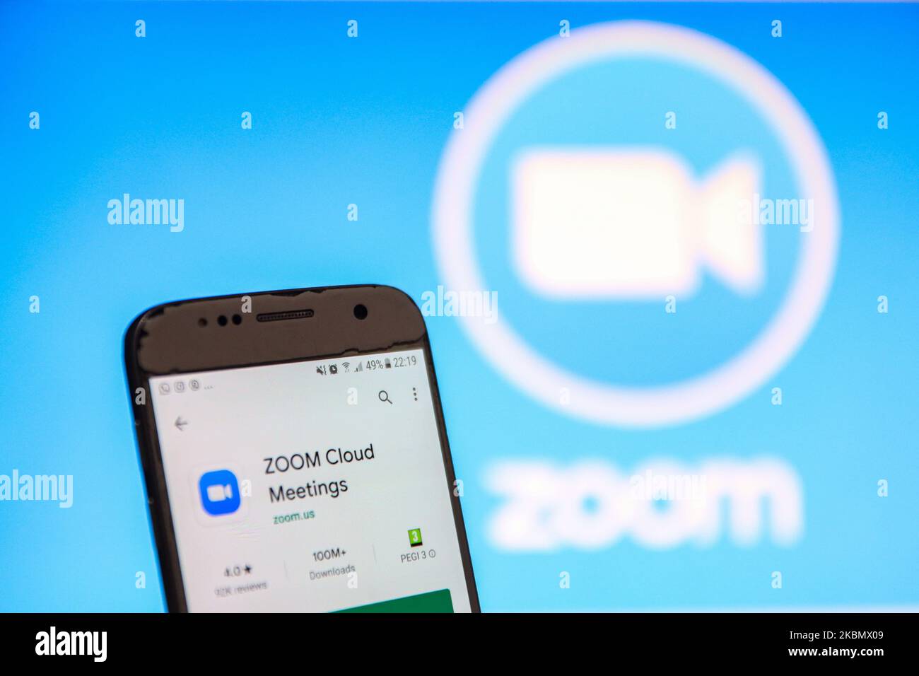 ZOOM Video Communications logo displayed on a phone screen, thumbnails ...