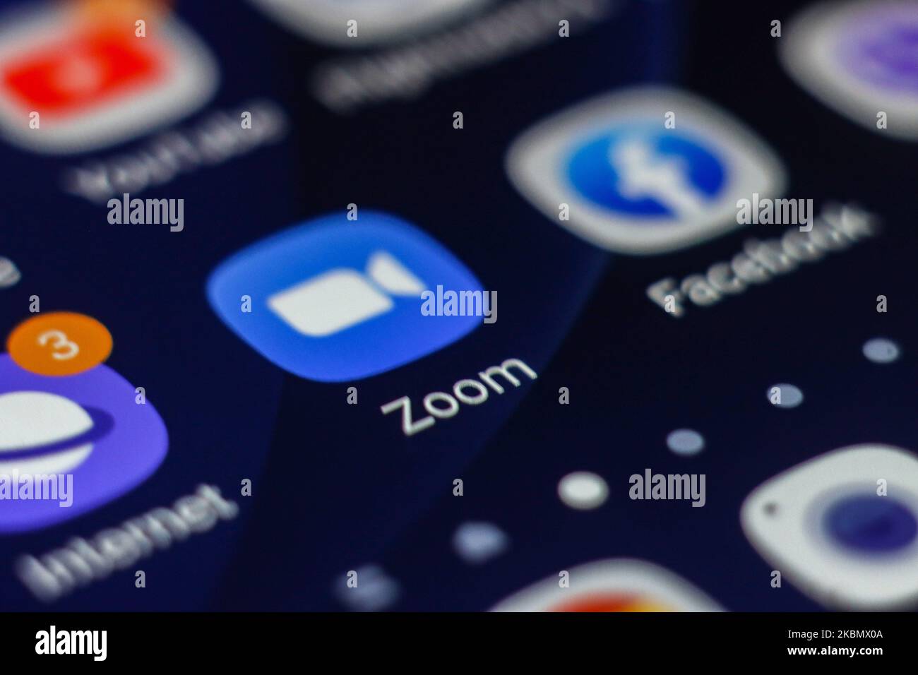 ZOOM Video Communications logo displayed on a phone screen, thumbnails ...