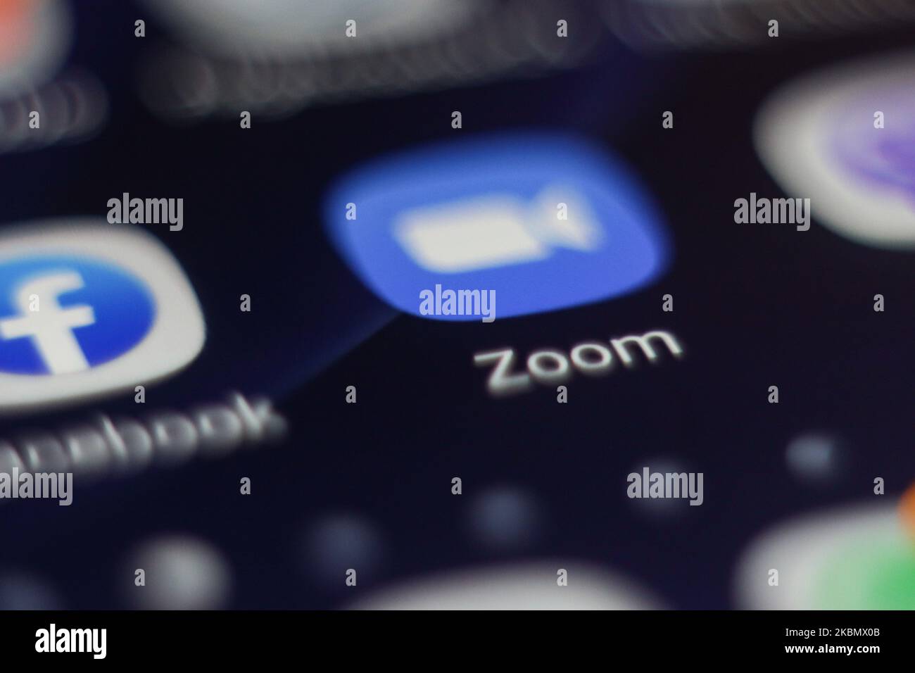 ZOOM Video Communications logo displayed on a phone screen, thumbnails ...