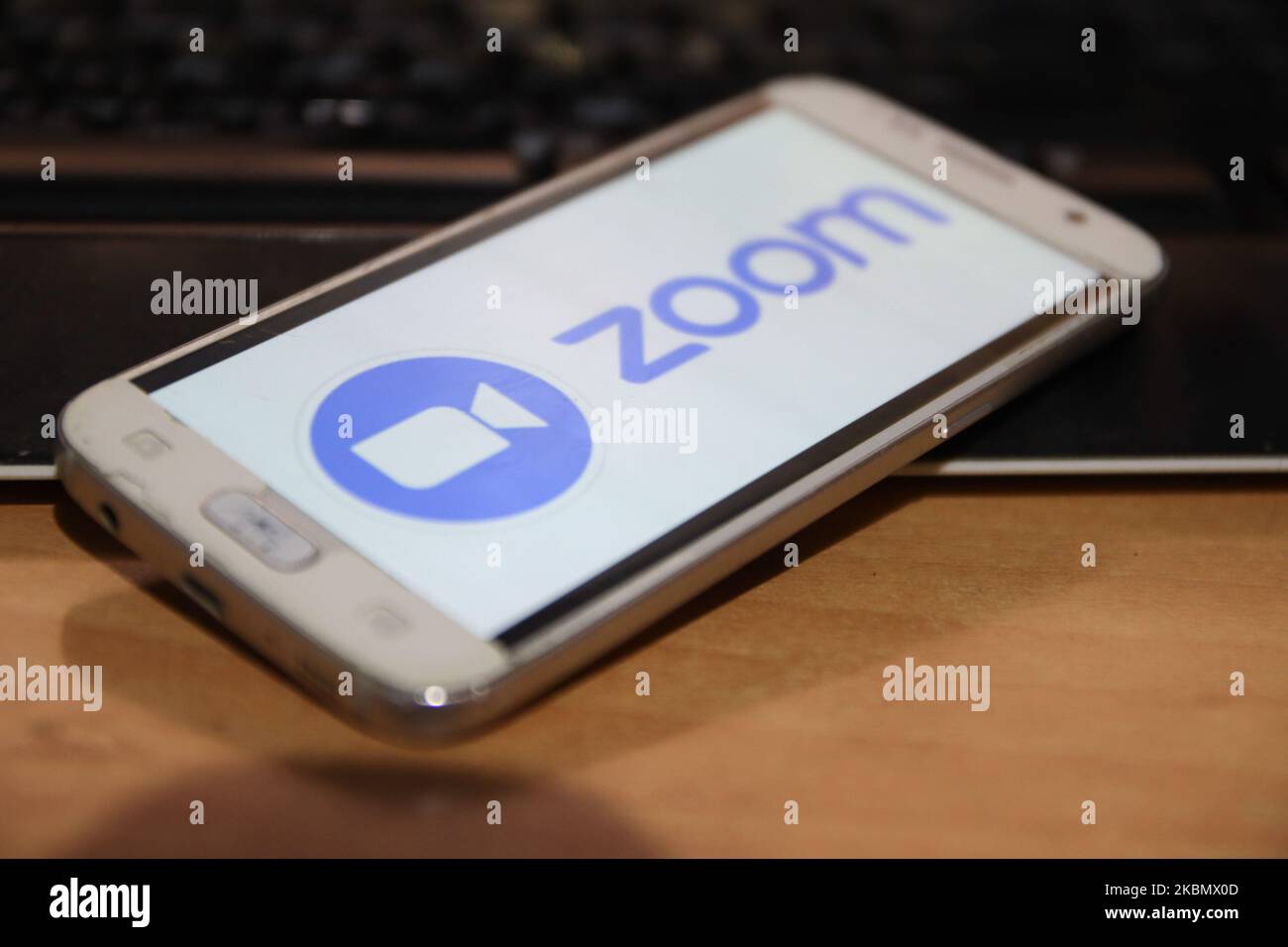ZOOM Video Communications logo displayed on a phone screen, thumbnails ...