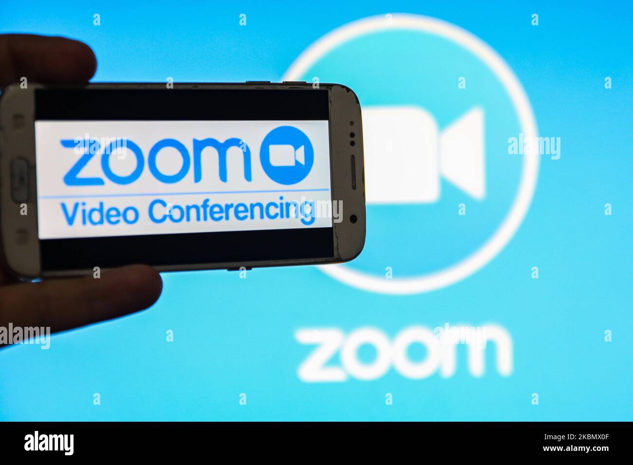 ZOOM Video Communications logo displayed on a phone screen, thumbnails ...