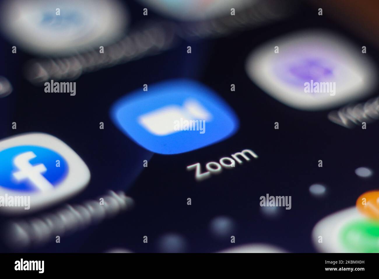 ZOOM Video Communications logo displayed on a phone screen, thumbnails ...