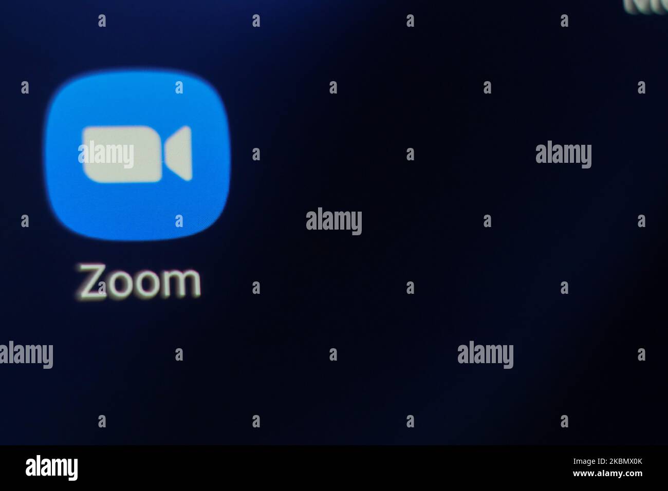 ZOOM Video Communications logo displayed on a phone screen, thumbnails ...