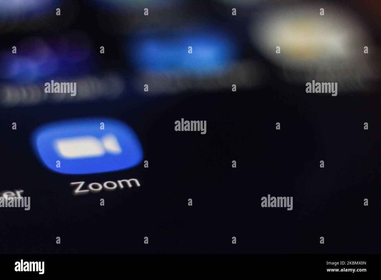 ZOOM Video Communications logo displayed on a phone screen, thumbnails ...