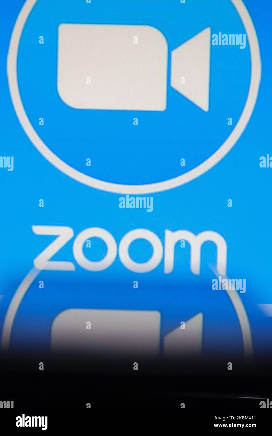ZOOM Video Communications logo displayed on a phone screen, thumbnails ...