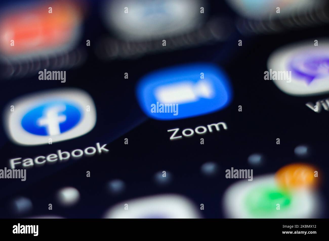 ZOOM Video Communications logo displayed on a phone screen, thumbnails ...