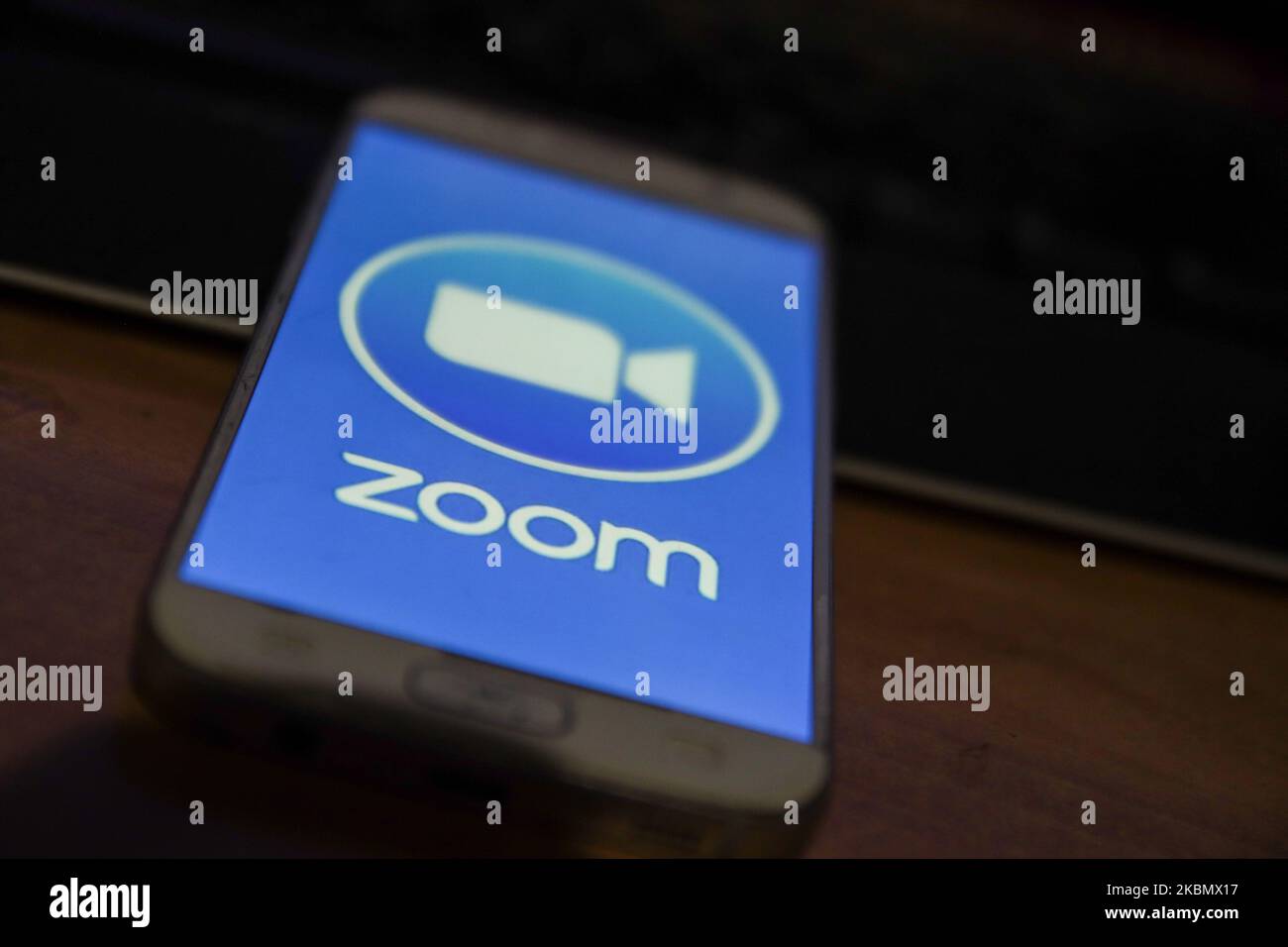 ZOOM Video Communications logo displayed on a phone screen, thumbnails ...