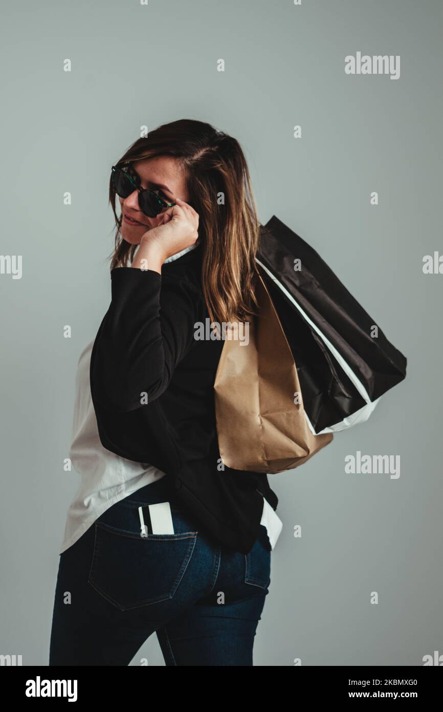 girl with her shopping bags on her shoulder looking backwards Stock ...
