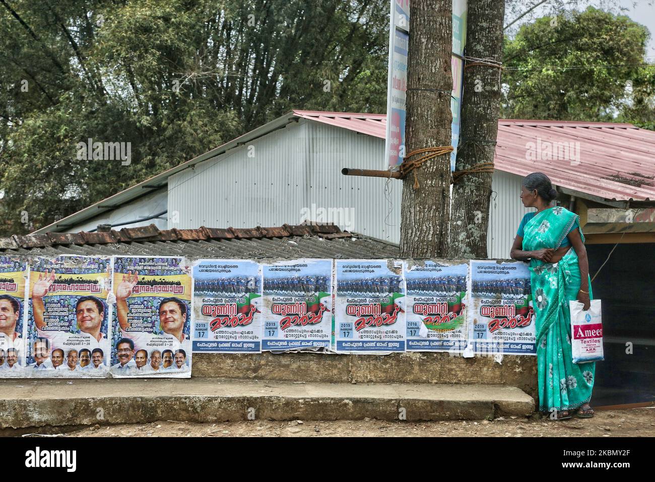 Tamil woman stands by the roadside in the small village of Pooppara ...