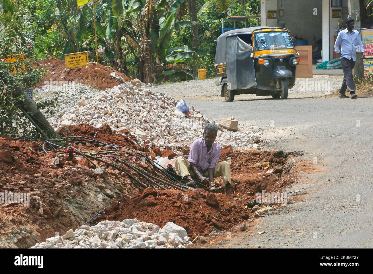 Worker connects telephone wires by the roadside in the small village of ...