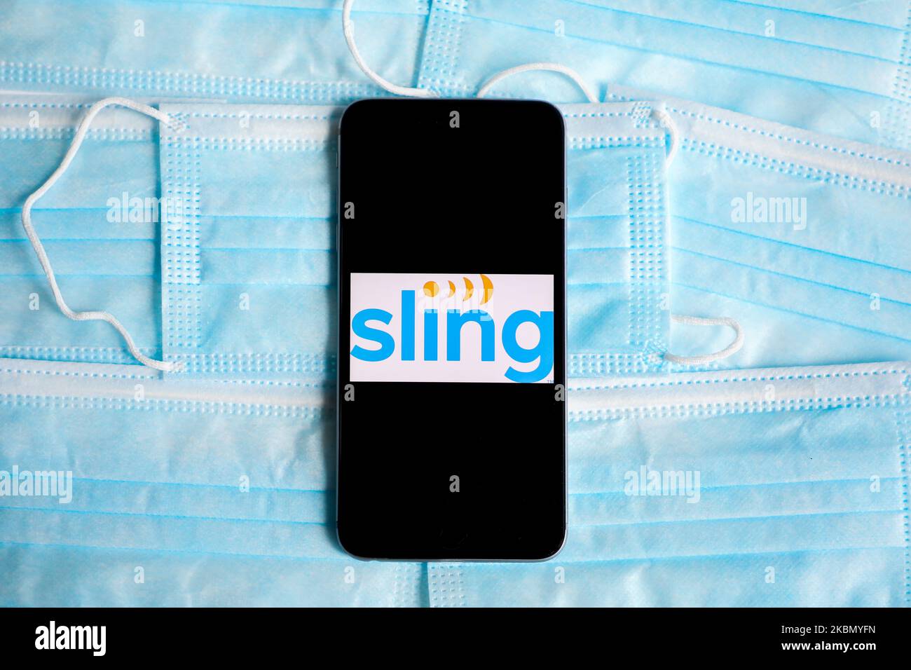 Sling logo is displayed on a mobile phone screen photographed on ...