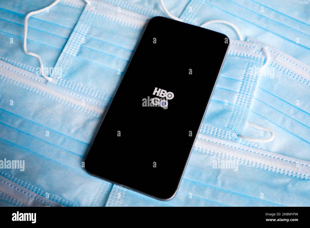 HBO GO logo is displayed on a mobile phone screen photographed on ...