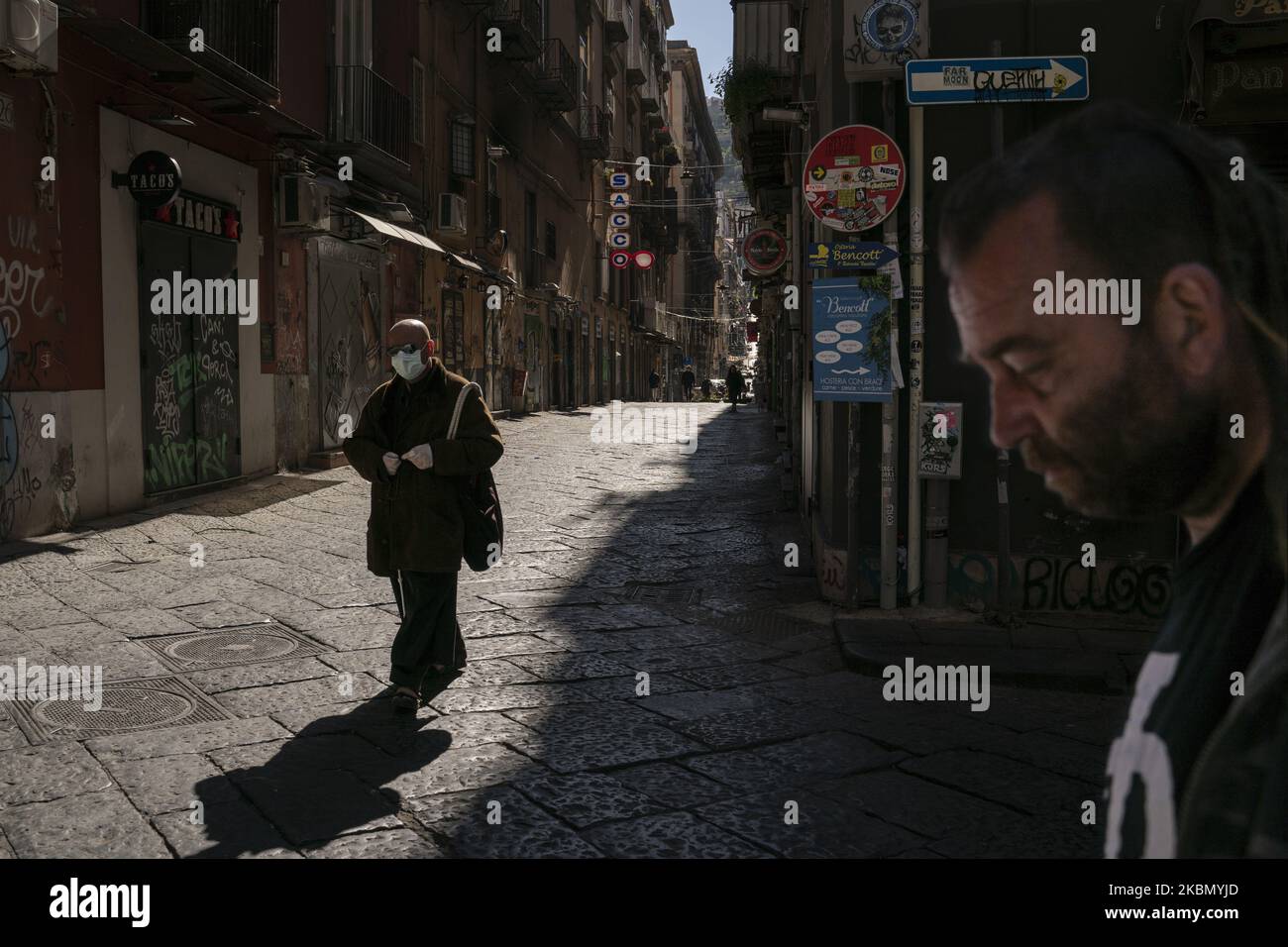 A Franciscan monk crosses path with a homeless person in the empty ...