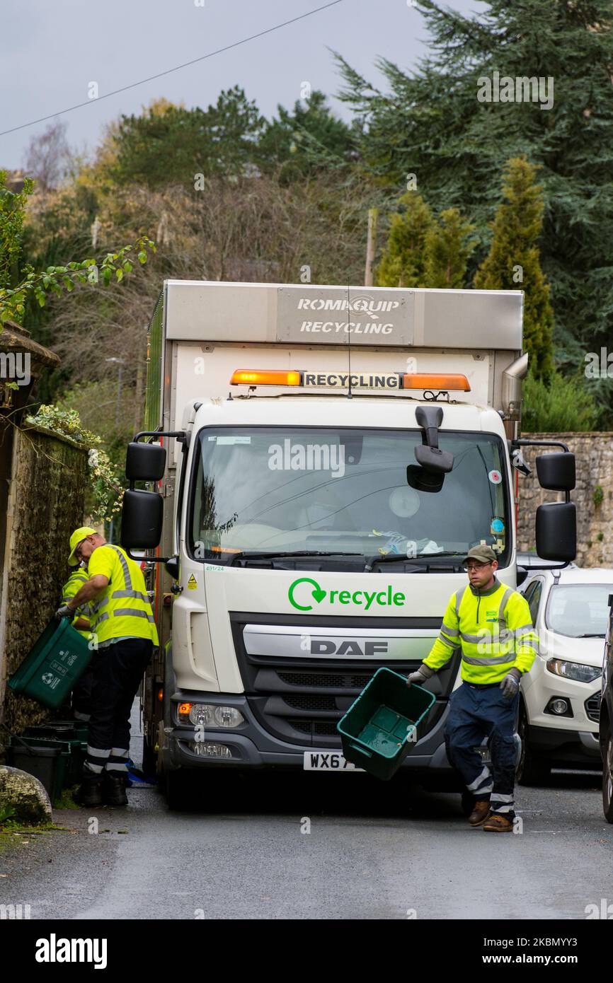 Council workers collect recycling refuse on a specially designed truck ...