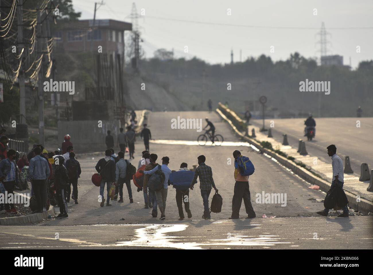Nepalese people carrying their belongings to travel back home during ...