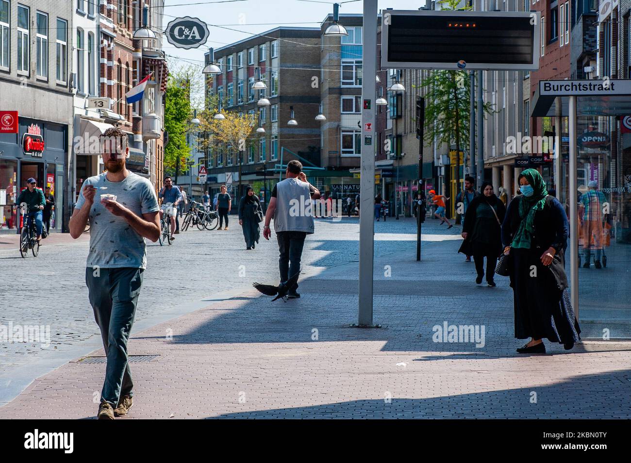 A Muslim woman is waling on the street while wearing a mask, during the ...
