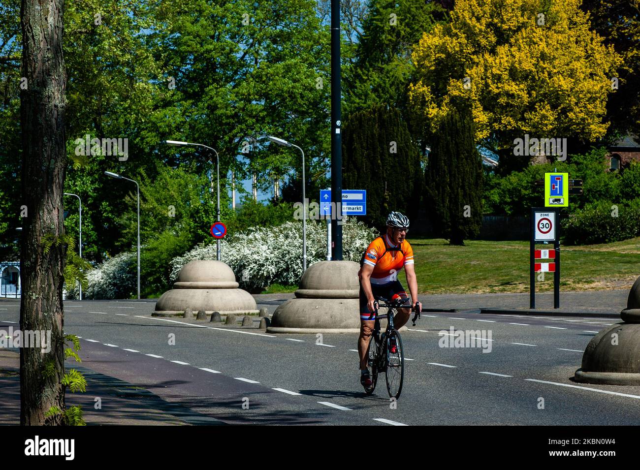 A cyclist is using orange clothes, during the celebration of King's day ...