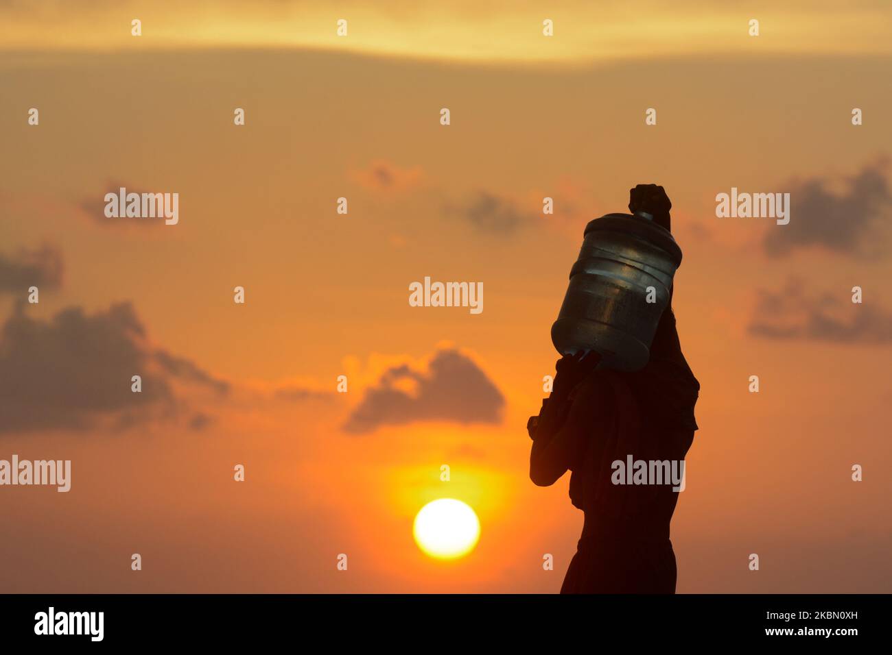 man carrying water boolean during a nationwide curfew spread of the ...