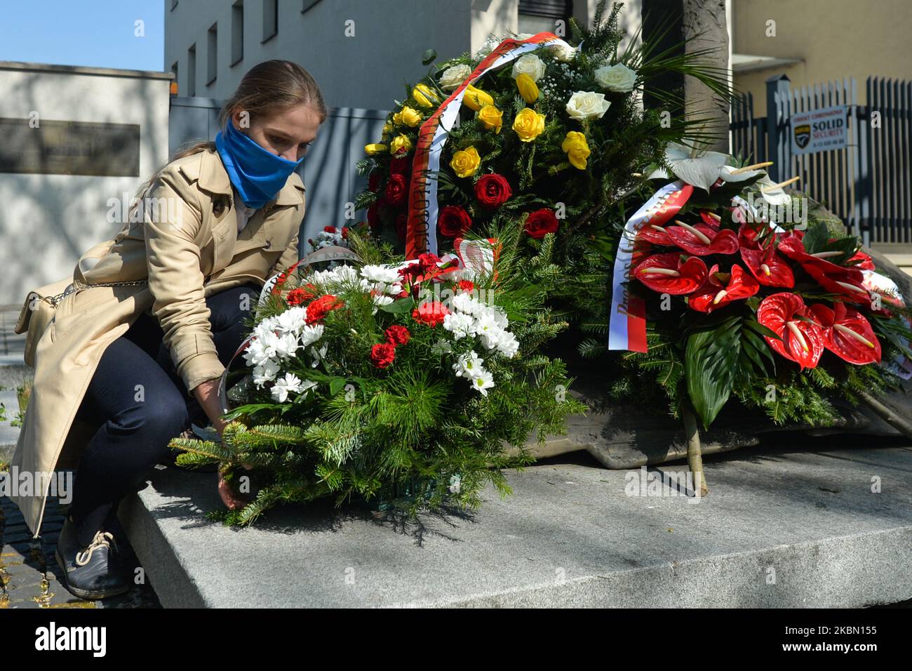 People bring flowers, candles and wreaths to the Nowa Huta cross ...