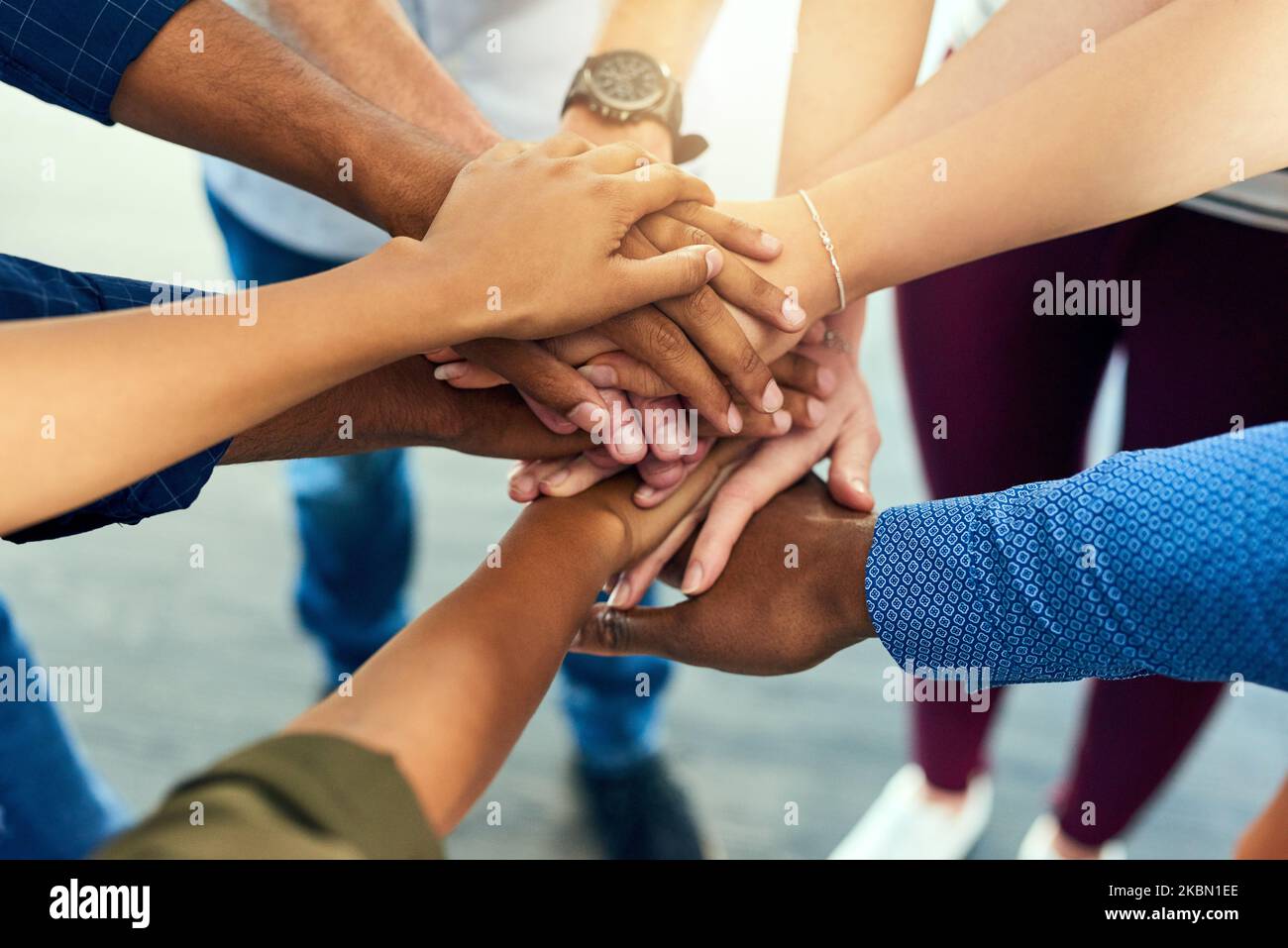 All together guys. a group unrecognizable people putting their hands ...