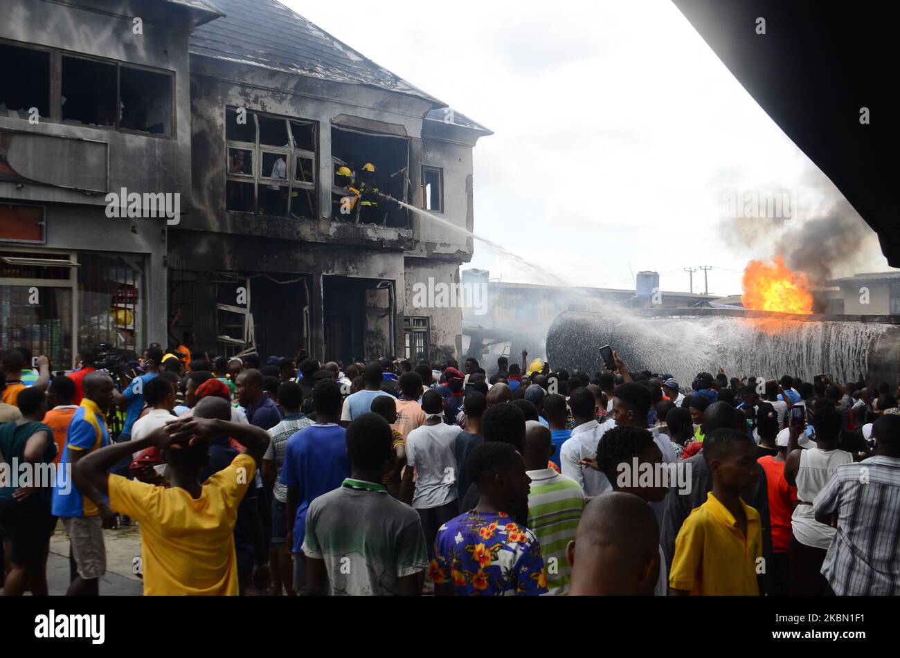 Crowds gather at the scene of the fire outbreak ignoring the social ...