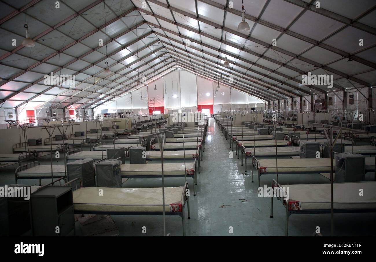 Bangladeshi workers prepare a makeshift hospital for the treatment of ...