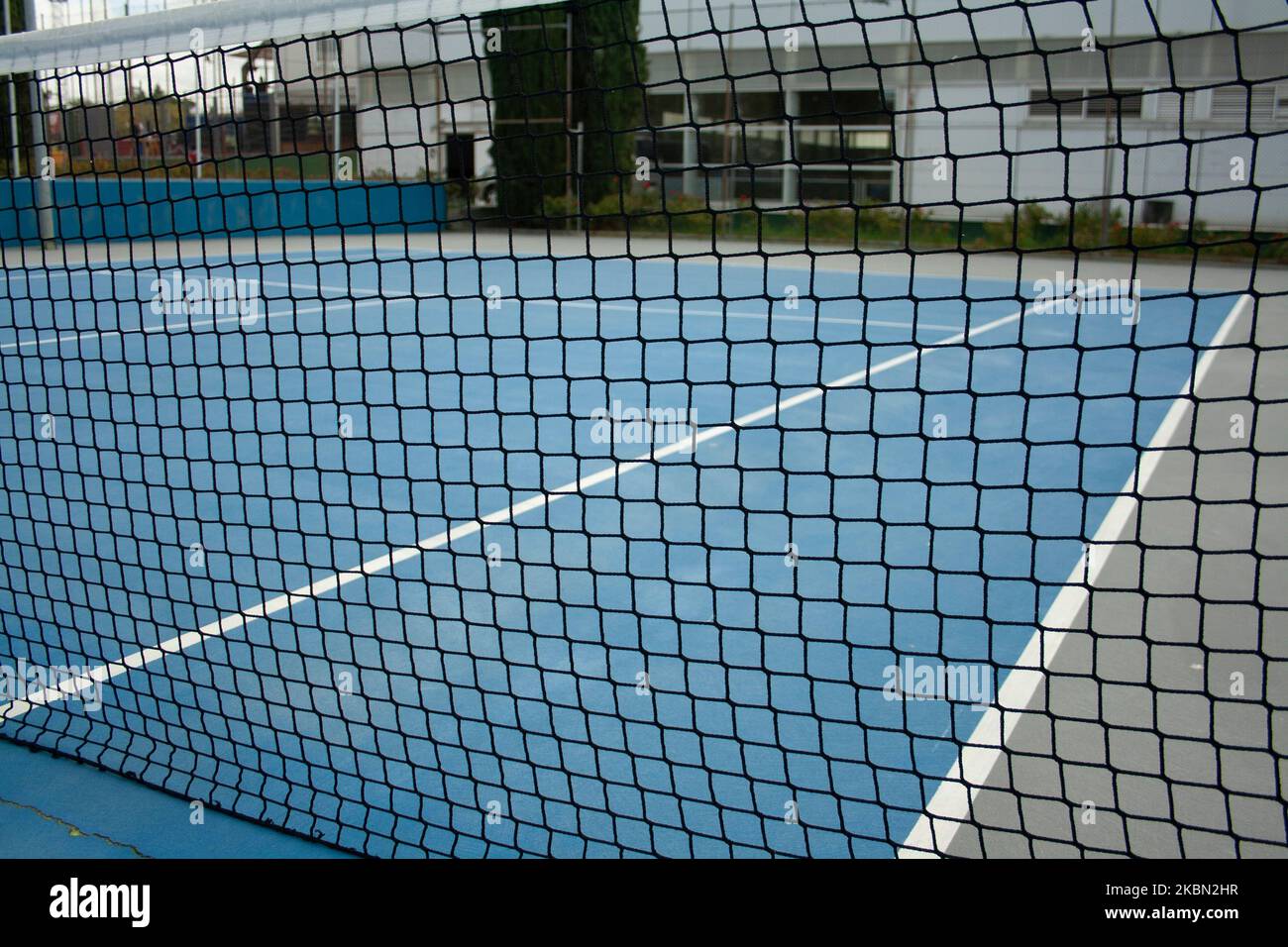 hard blue tennis court where you can see its straight lines as well as ...