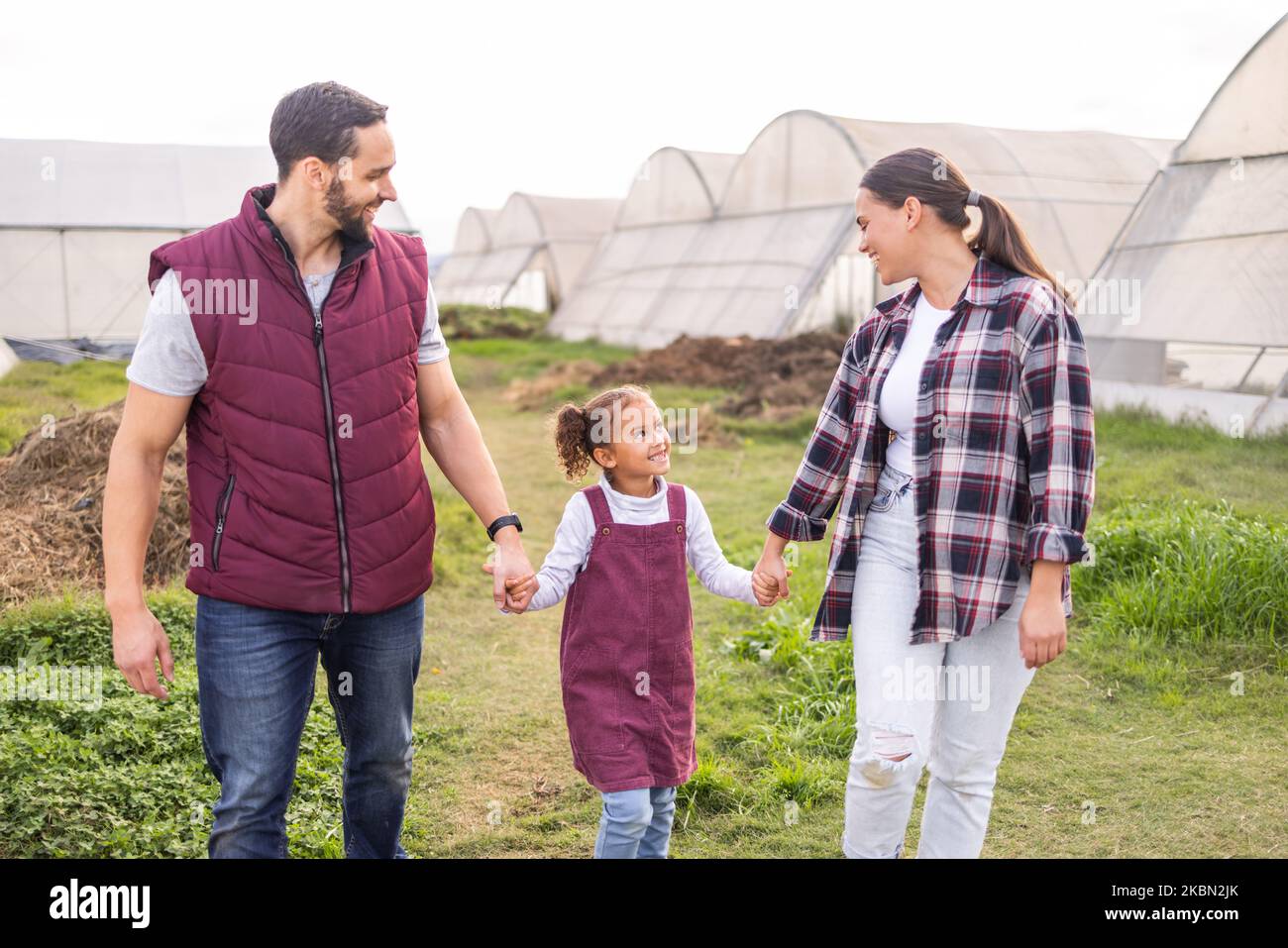 Farming, field and parents holding hands with child walking on farm ...