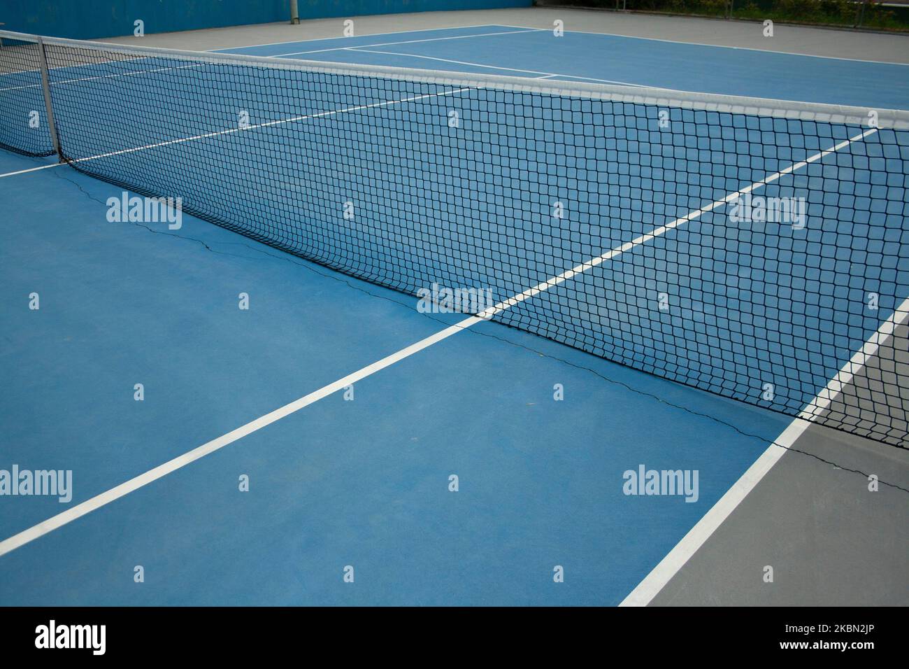 hard blue tennis court where you can see its straight lines as well as ...