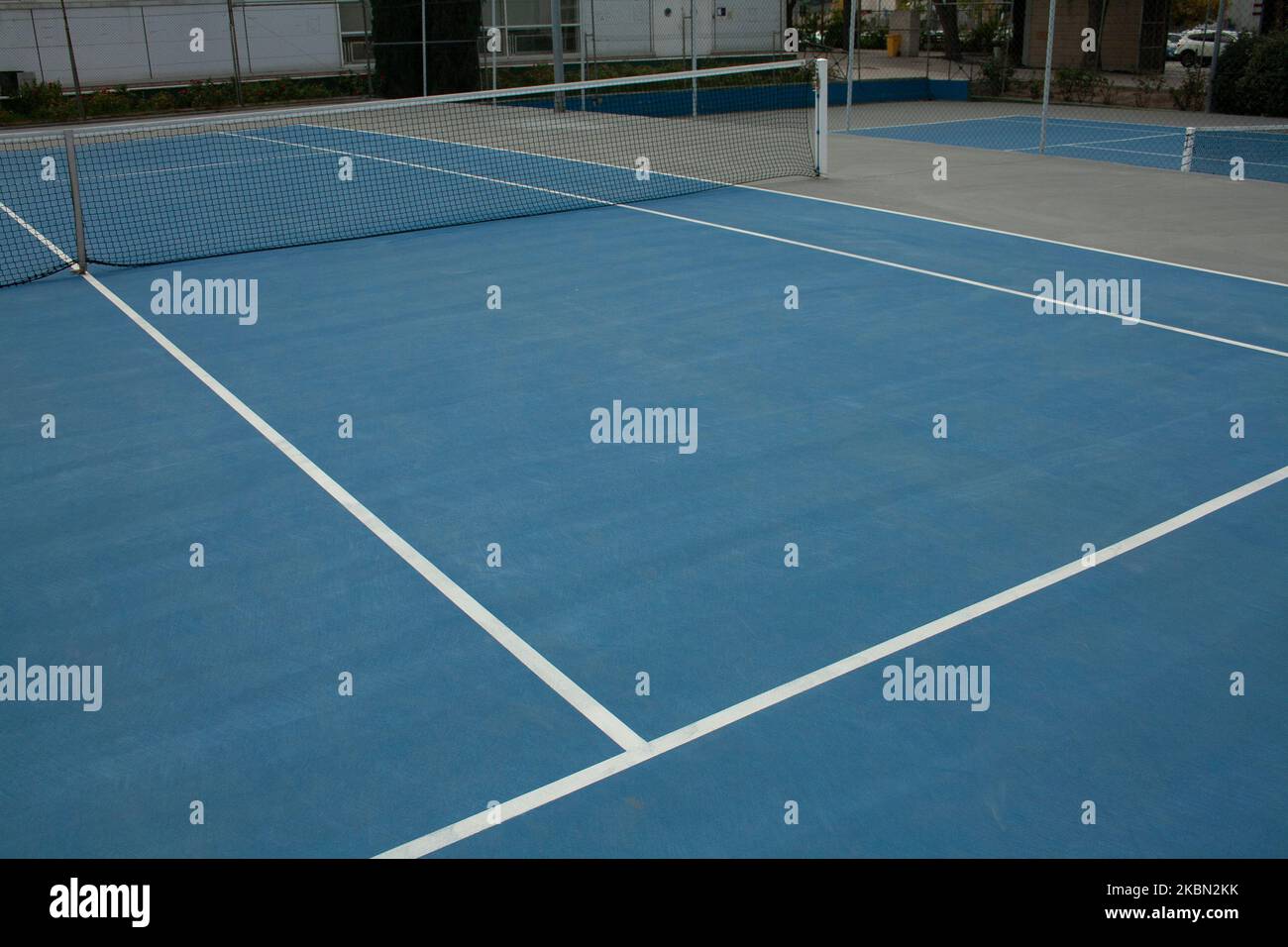 hard blue tennis court where you can see its straight lines as well as ...