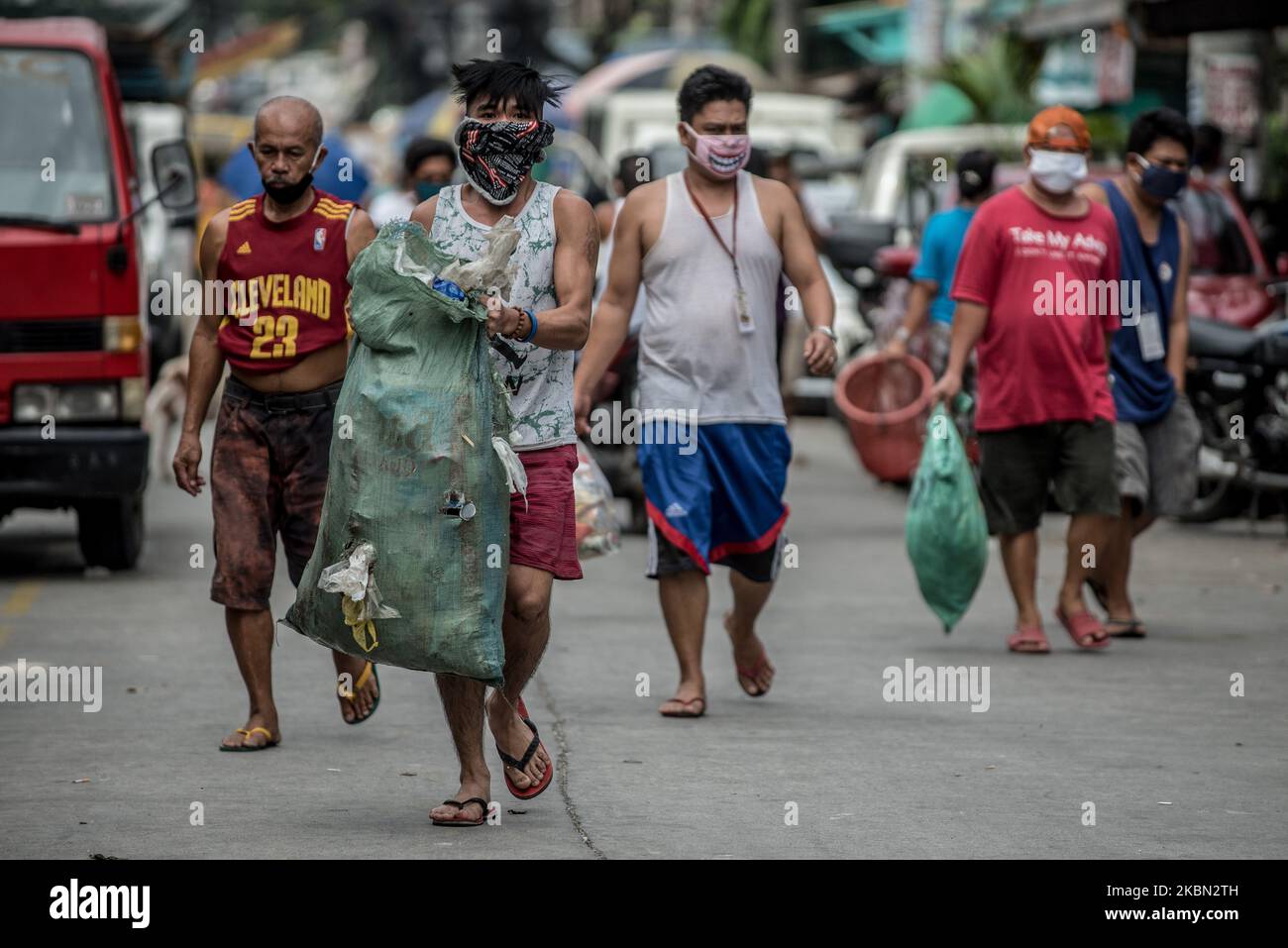 Residents bring out their household waste for garbage collectors to ...