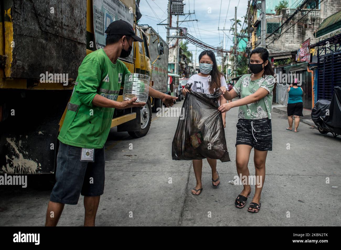 Residents bring out their household waste for garbage collectors to ...