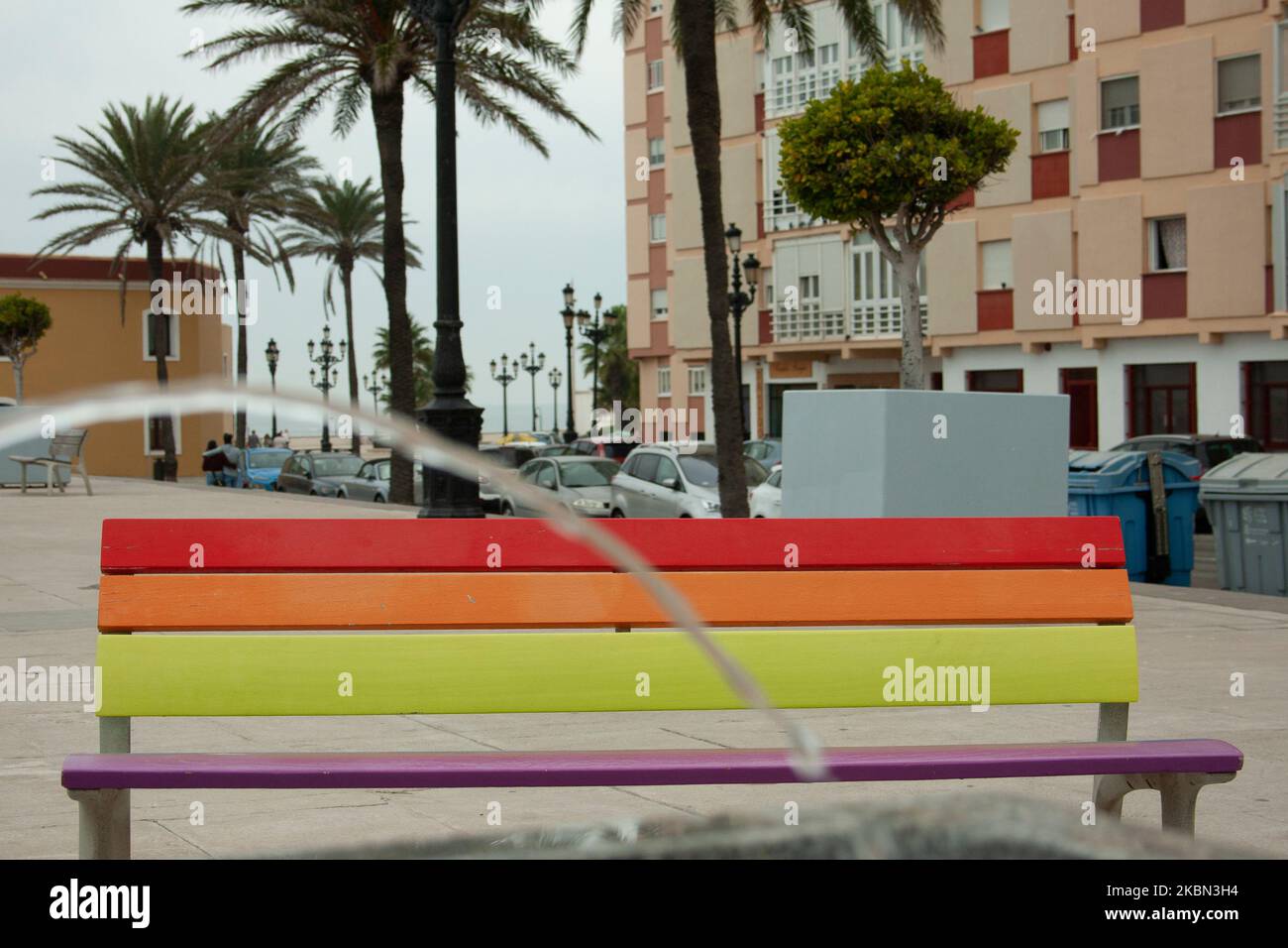 colored benches on the promenade of the city of Cadiz in Spain that ...