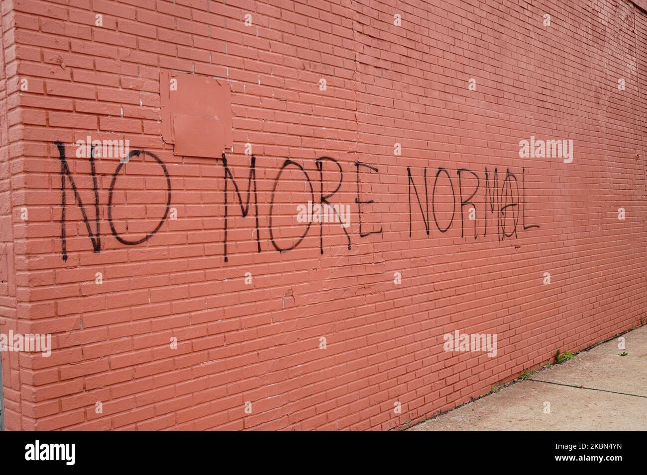 A view of a graffiti that says,” No More Normal” in Long Island City ...