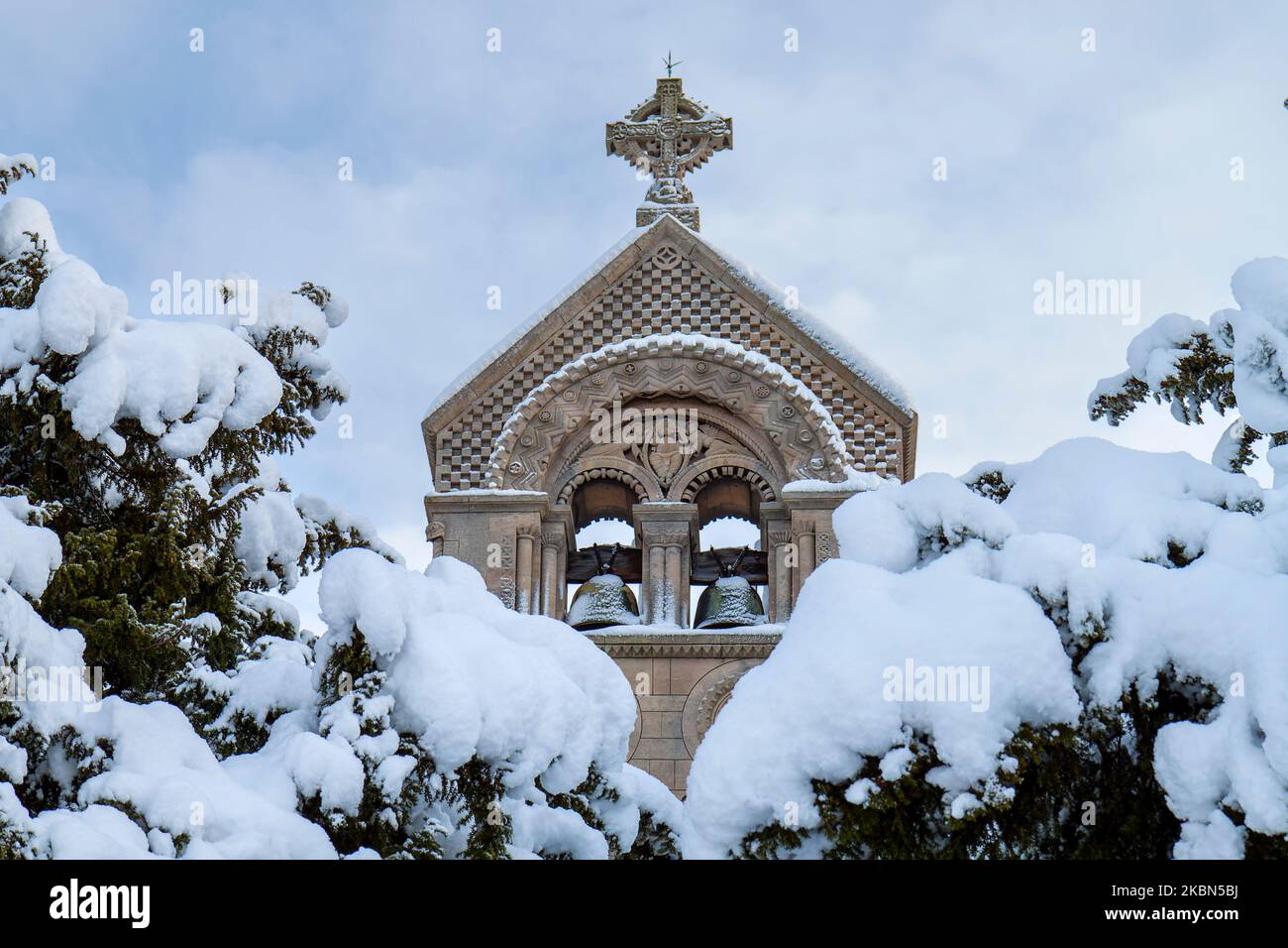 Two church bells atop a tower in the snow Stock Photo - Alamy