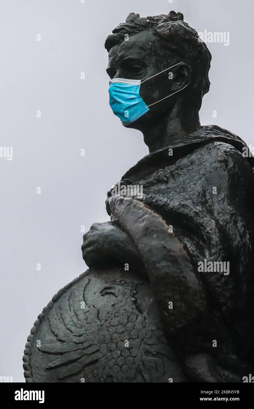 A sculpture being a fragment of Adam Mickiewicz statue is seen wearing ...