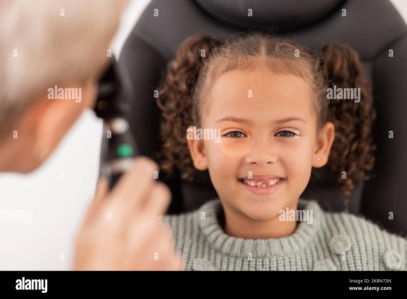 Happy portrait of girl, test eye vision by optician checking childs ...