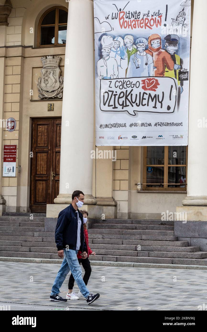 A father with daughter in protective face masks are seen enjoying a ...
