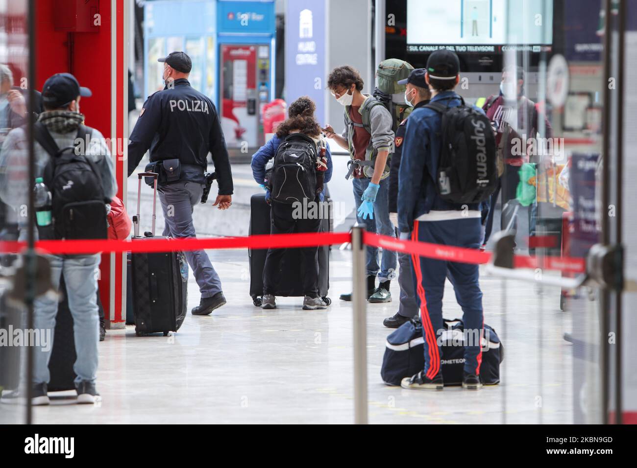 Police and military control travellers at the Milan railway station ...
