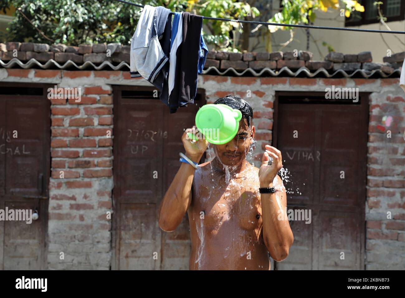 A boy takes bath in one of the Slums amid nationwide lockdown imposed ...