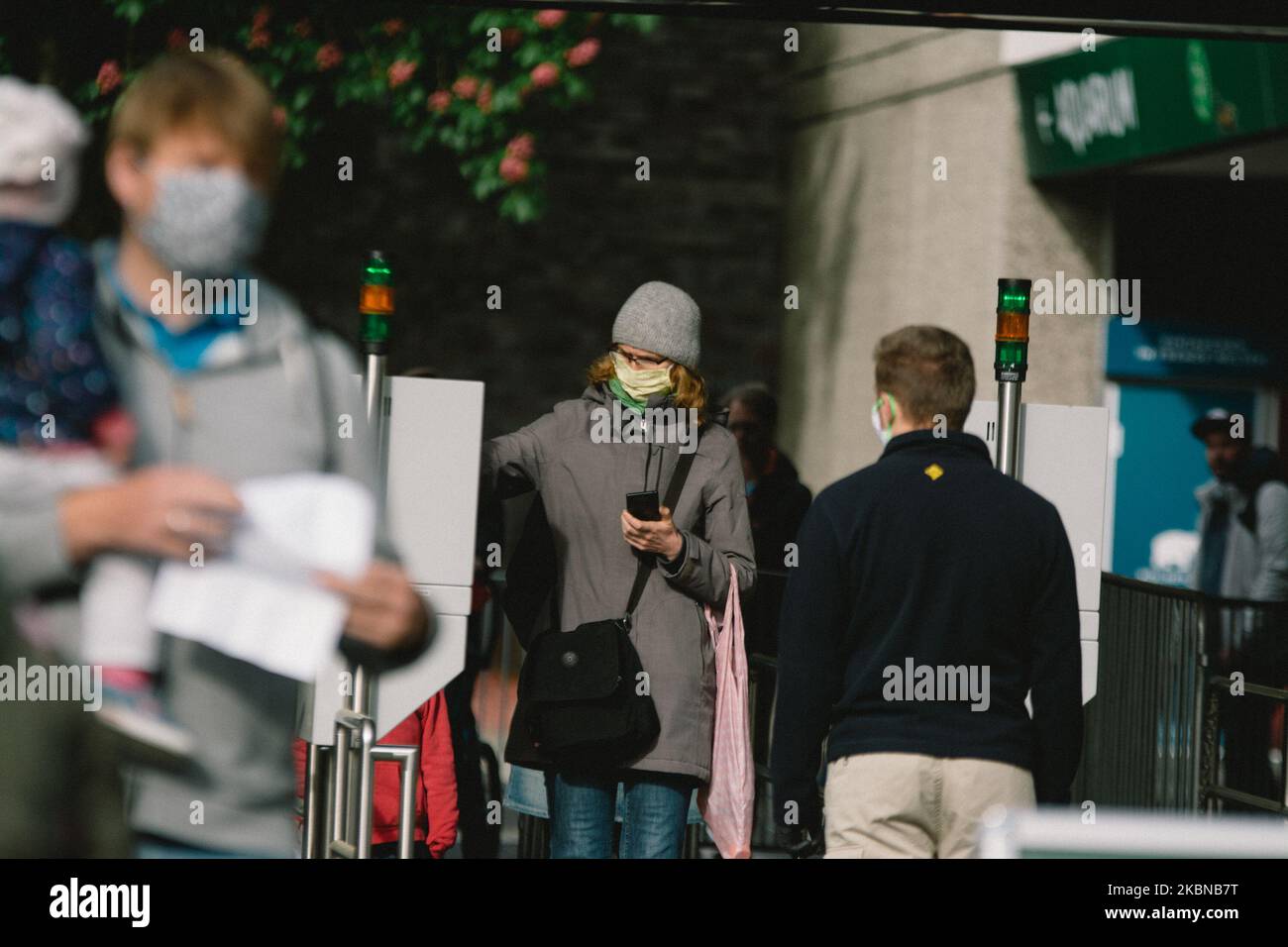 visitor scans the entrance code at the gate of cologne zoo after reopening for visitors in ...