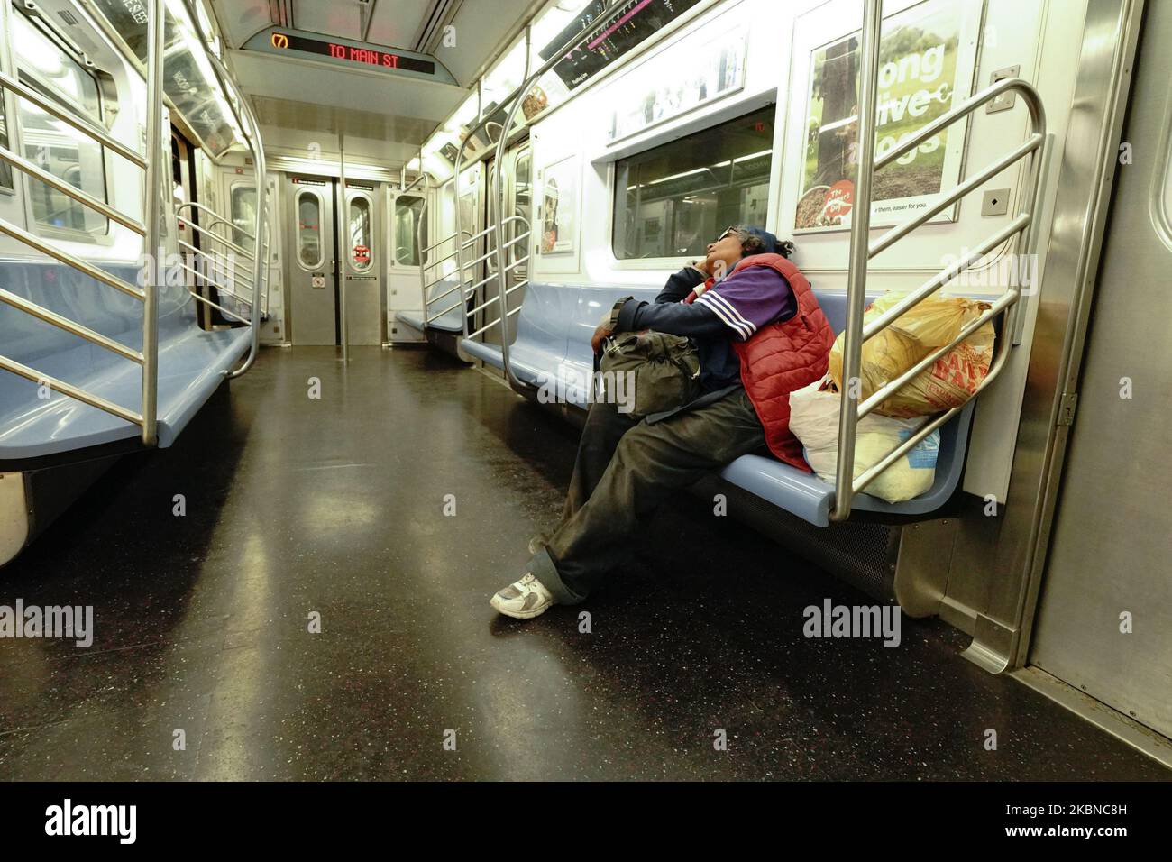 A view of a homeless person sleeping on a subway train in Hudson Yards ...