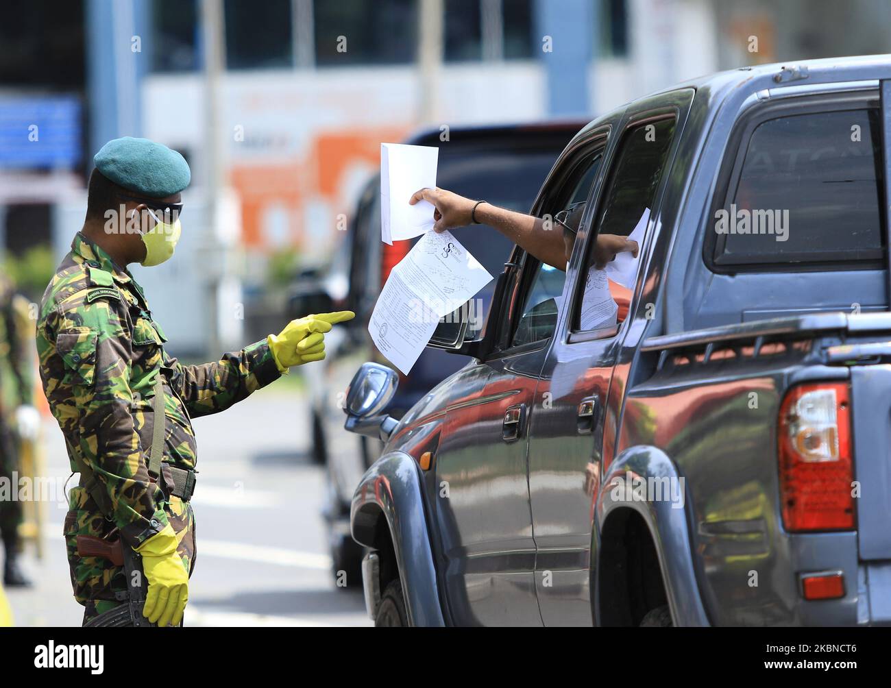 A Sri Lankan Army soldier wearing protective face mask inspects ...