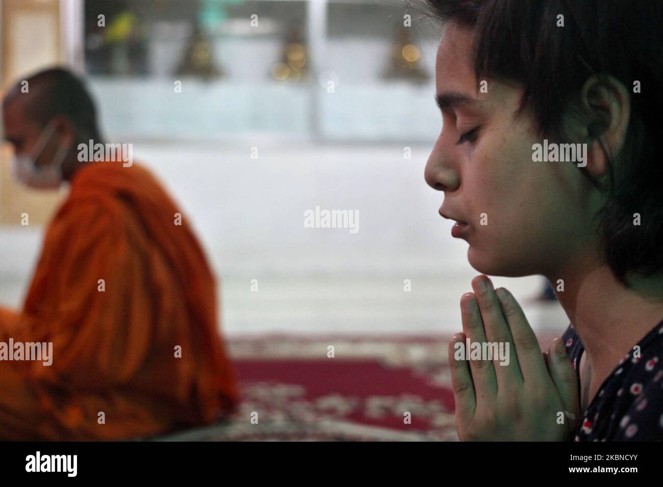 Buddhist devotee pray at a temple on the day of Buddha Purnima during a ...
