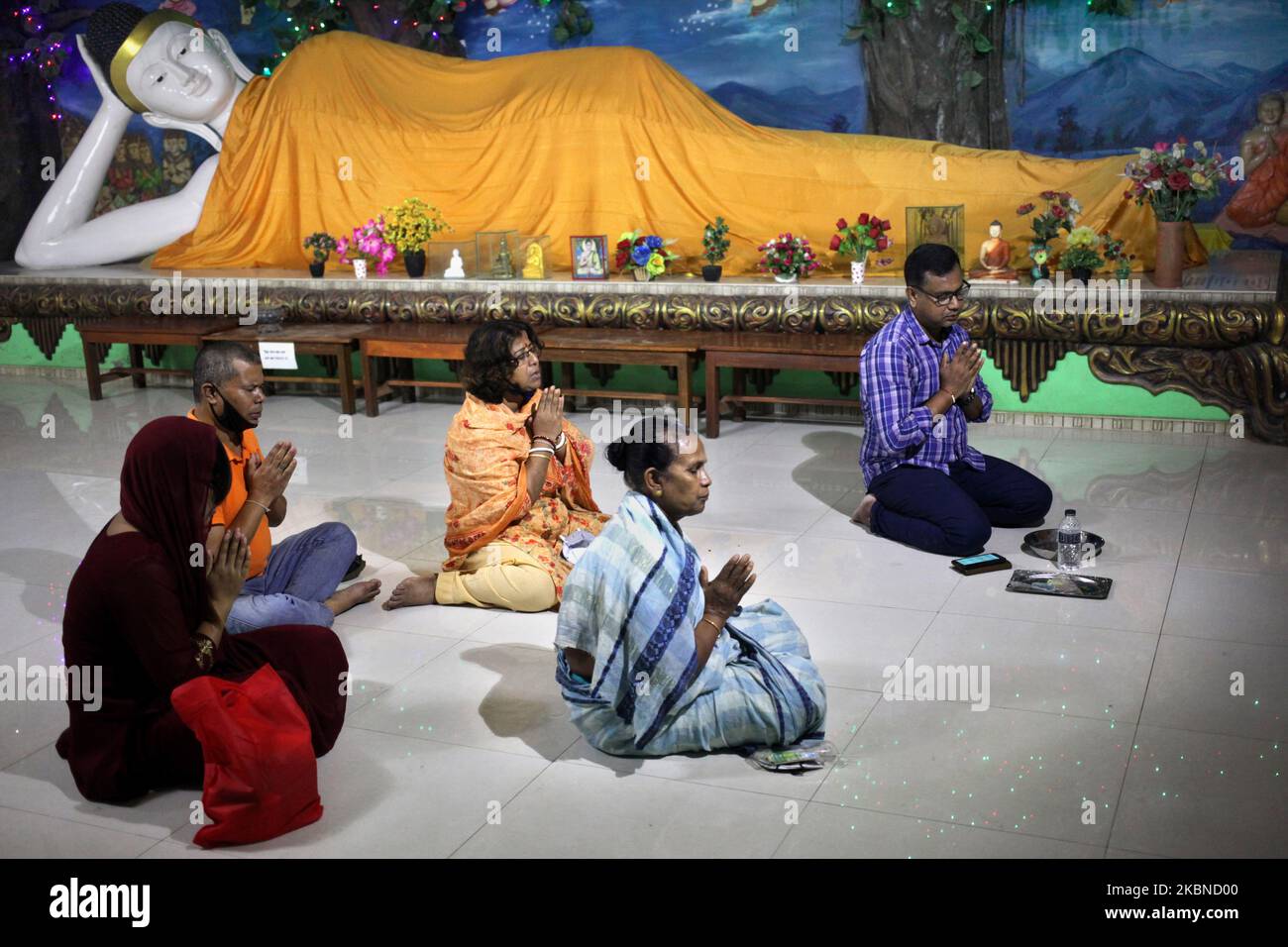 Buddhist devotee pray at a temple on the day of Buddha Purnima during a ...