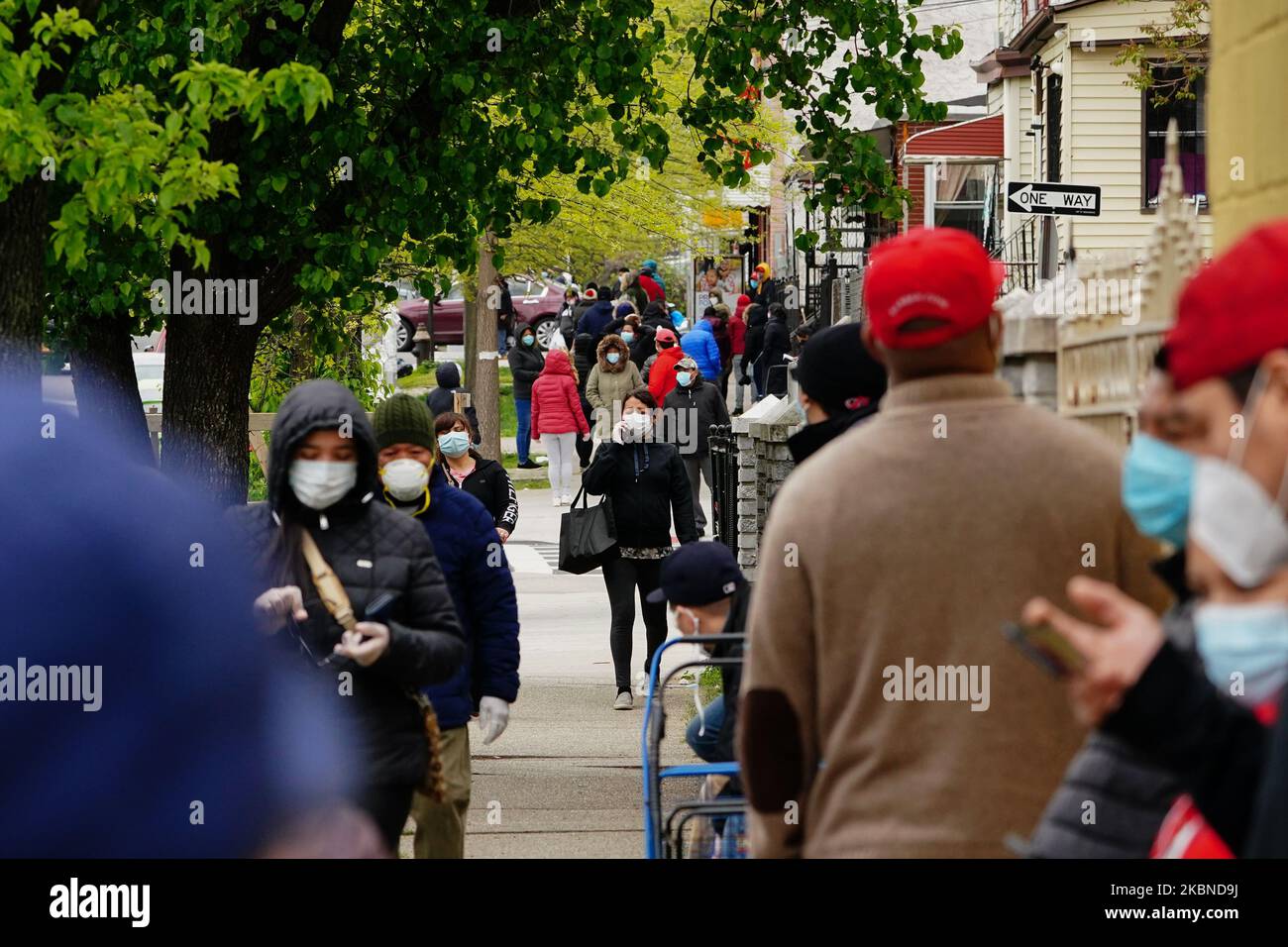 A view of a long line of people that stretches 4 blocks for relief ...