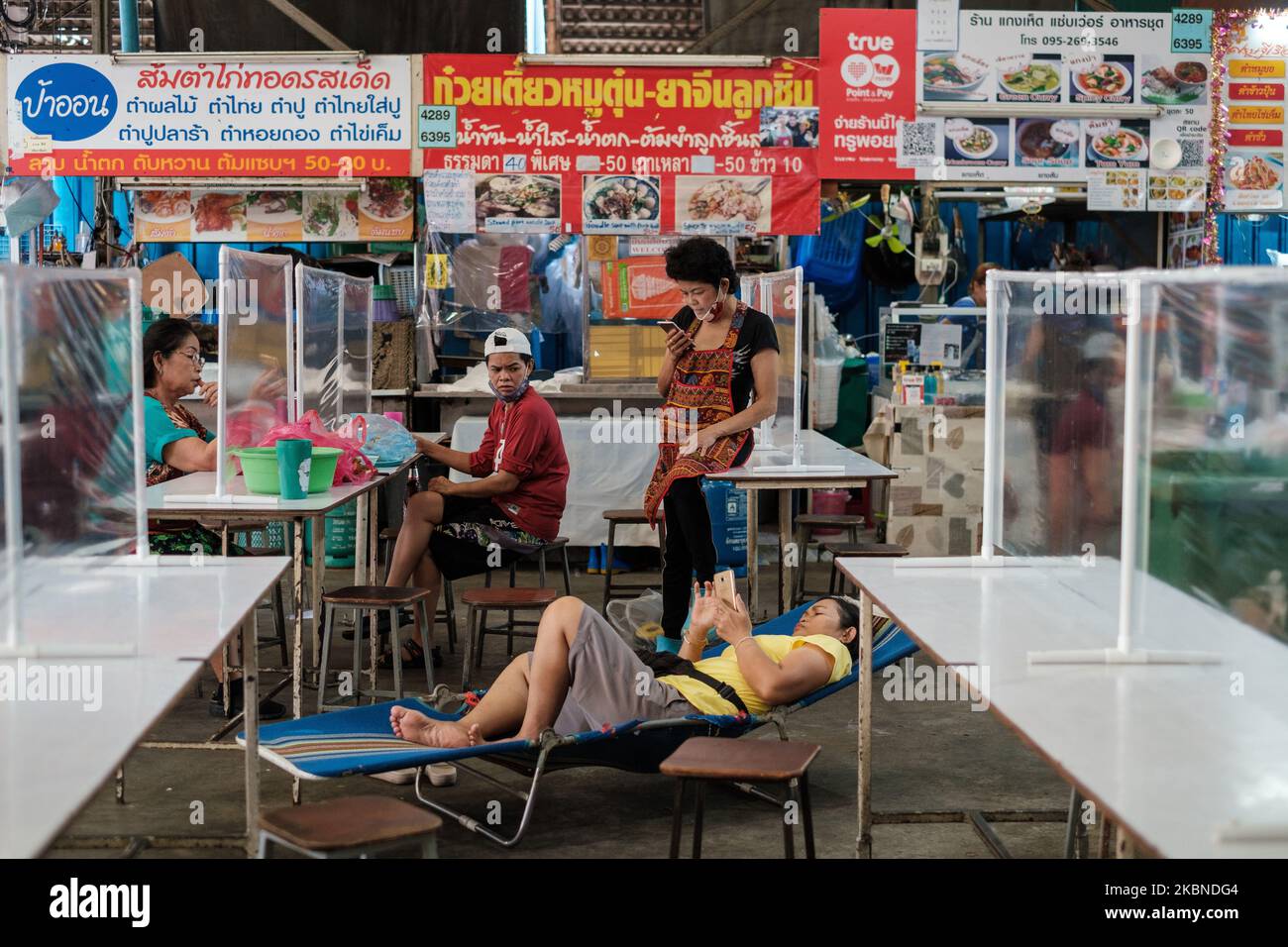 Food sellers take a break in a food court set up to welcome dine-in ...