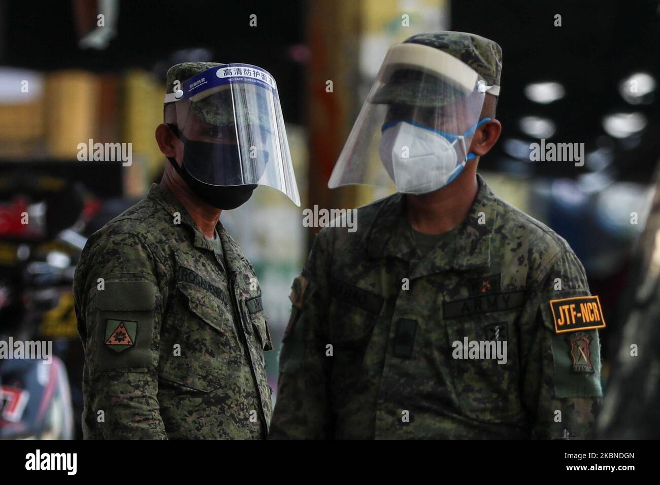 Members of the Philippine Army patrol the streets of a community placed ...