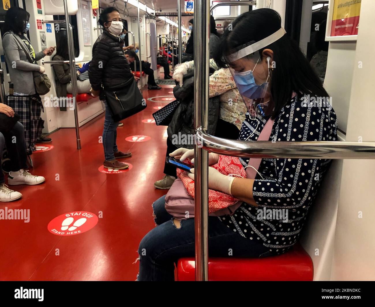 A passenger on the subway wears a mask and gloves that are mandatory ...