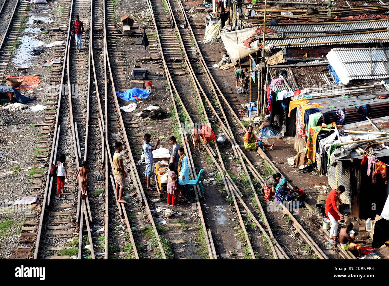 Peoples are living in the makeshift home in the slums of a next to ...
